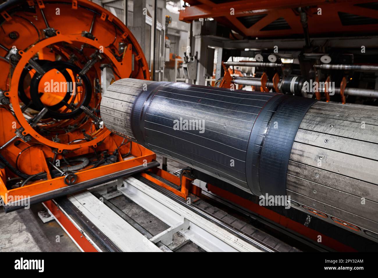 Metal shaft with rubber layers and equipment to form tire Stock Photo ...