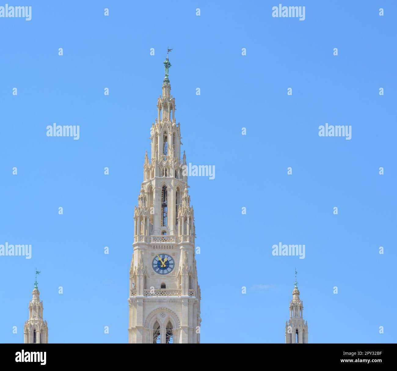 The clock tower of the town hall in Vienna against the blue sky in a ...