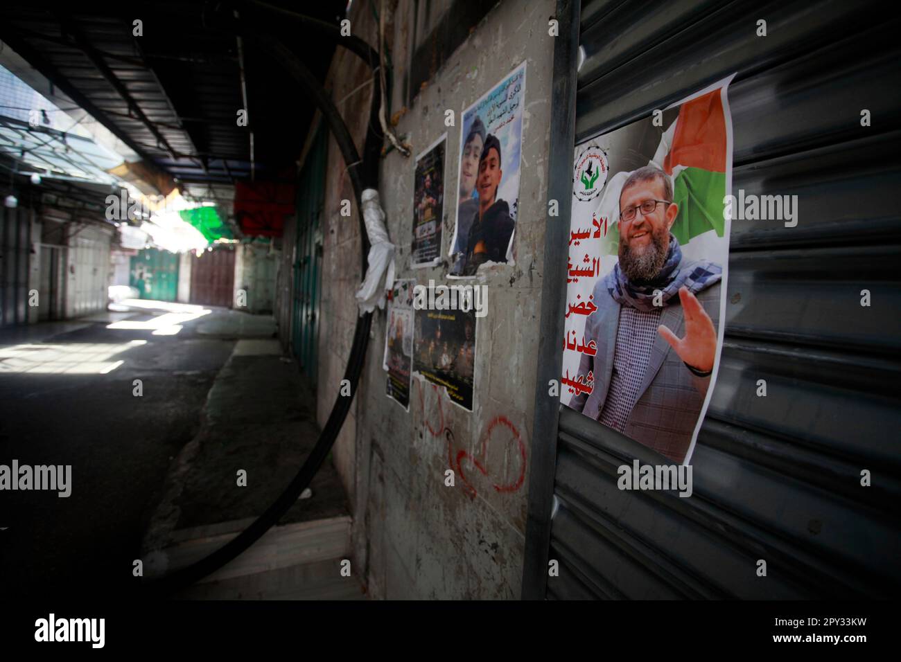 A portrait of the late Palestinian prisoner Khader Adnan hangs on a ...