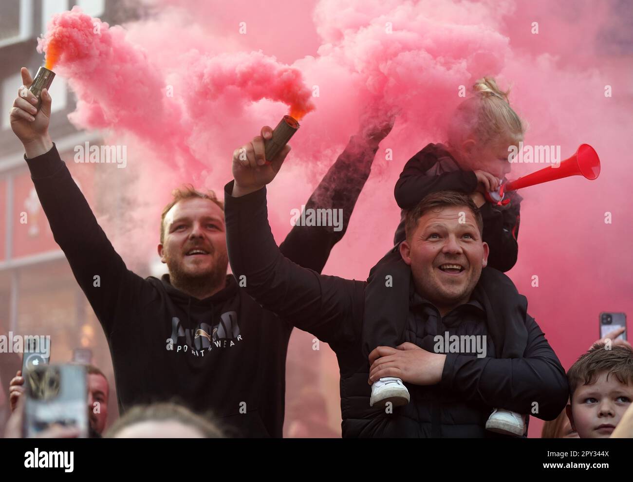 Wrexham fans set off flares during a victory parade in Wrexham, Wales ...