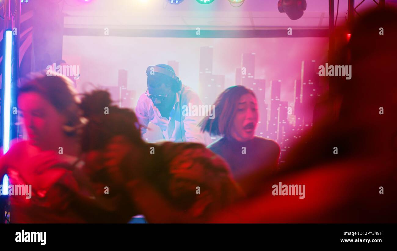 Party interrupted by police officers, cheeful people at nightclub ...