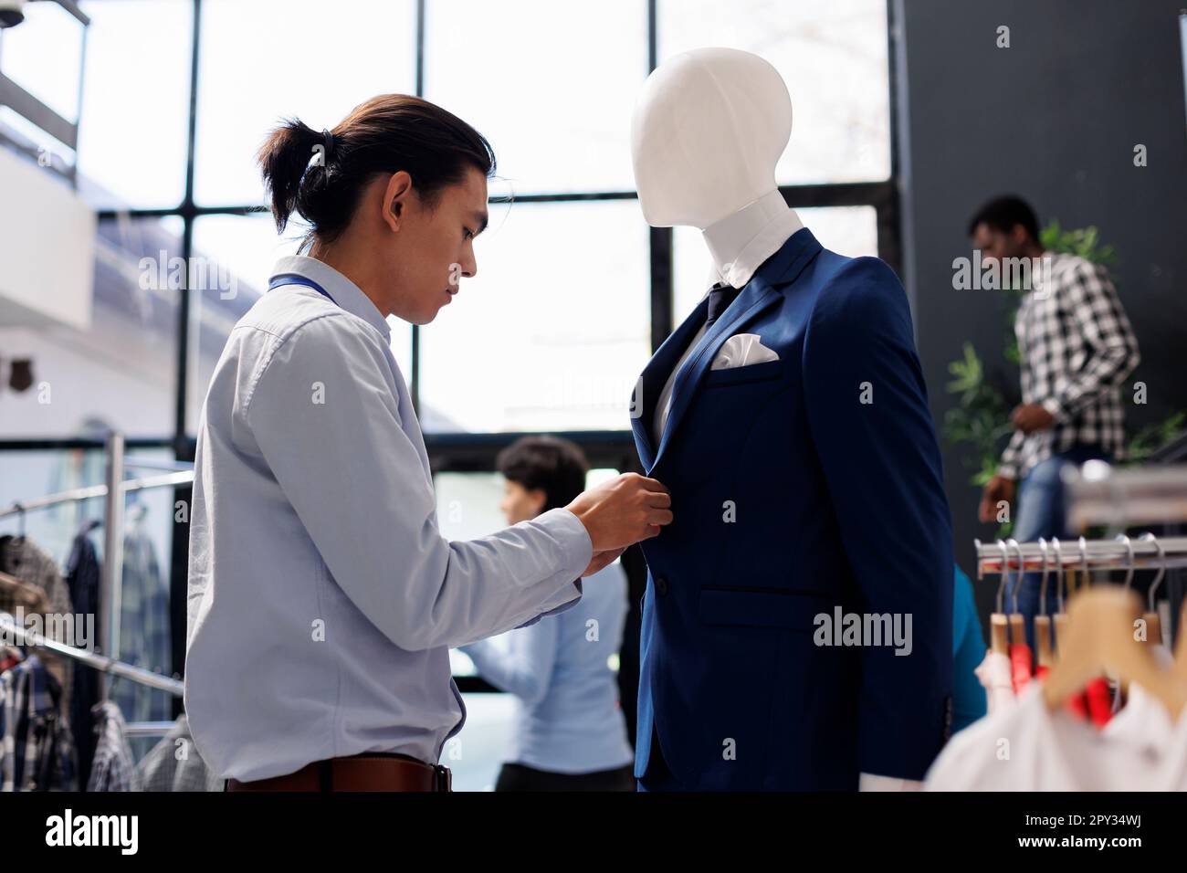 Worker arranging stylish clothes hi-res stock photography and images ...