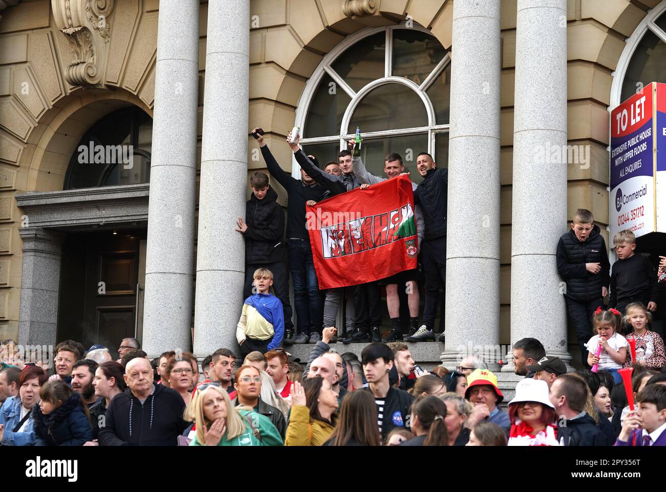 Wrexham fans celebrate during a victory parade in Wrexham, Wales ...