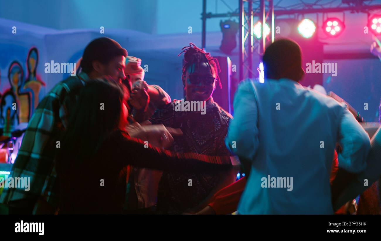 Diverse people waltzing in nightclub, attending cool party with friends ...