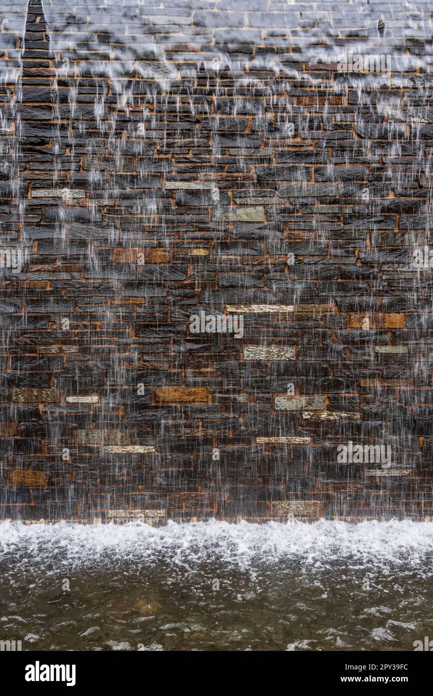 Stone wall and water stream. Background Stock Photo - Alamy