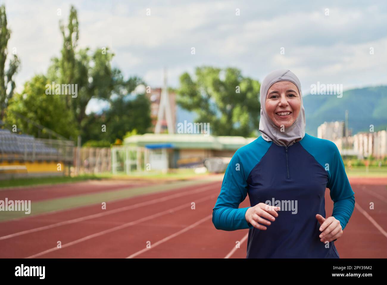 A muslim woman in a burqa sports muslim clothes running on a marathon ...