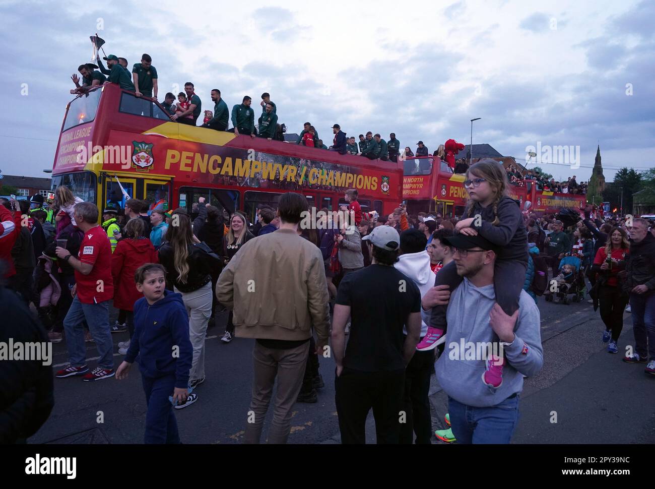 Wrexham players celebrate on an open-top bus during a victory parade in ...