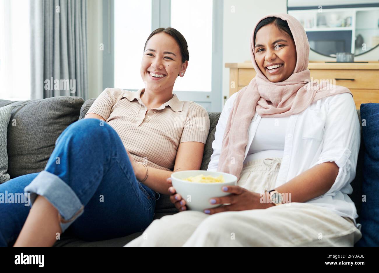 This is the perfect bonding session. two women sitting on the sofa at ...
