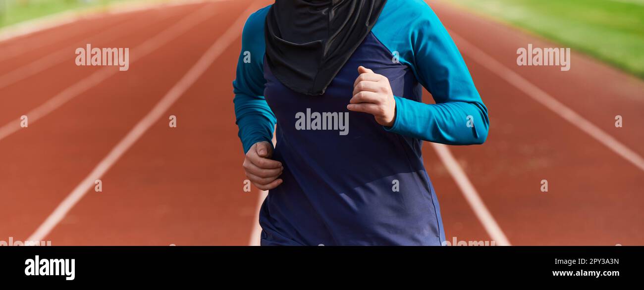 A muslim woman in a burqa sports muslim clothes running on a marathon ...