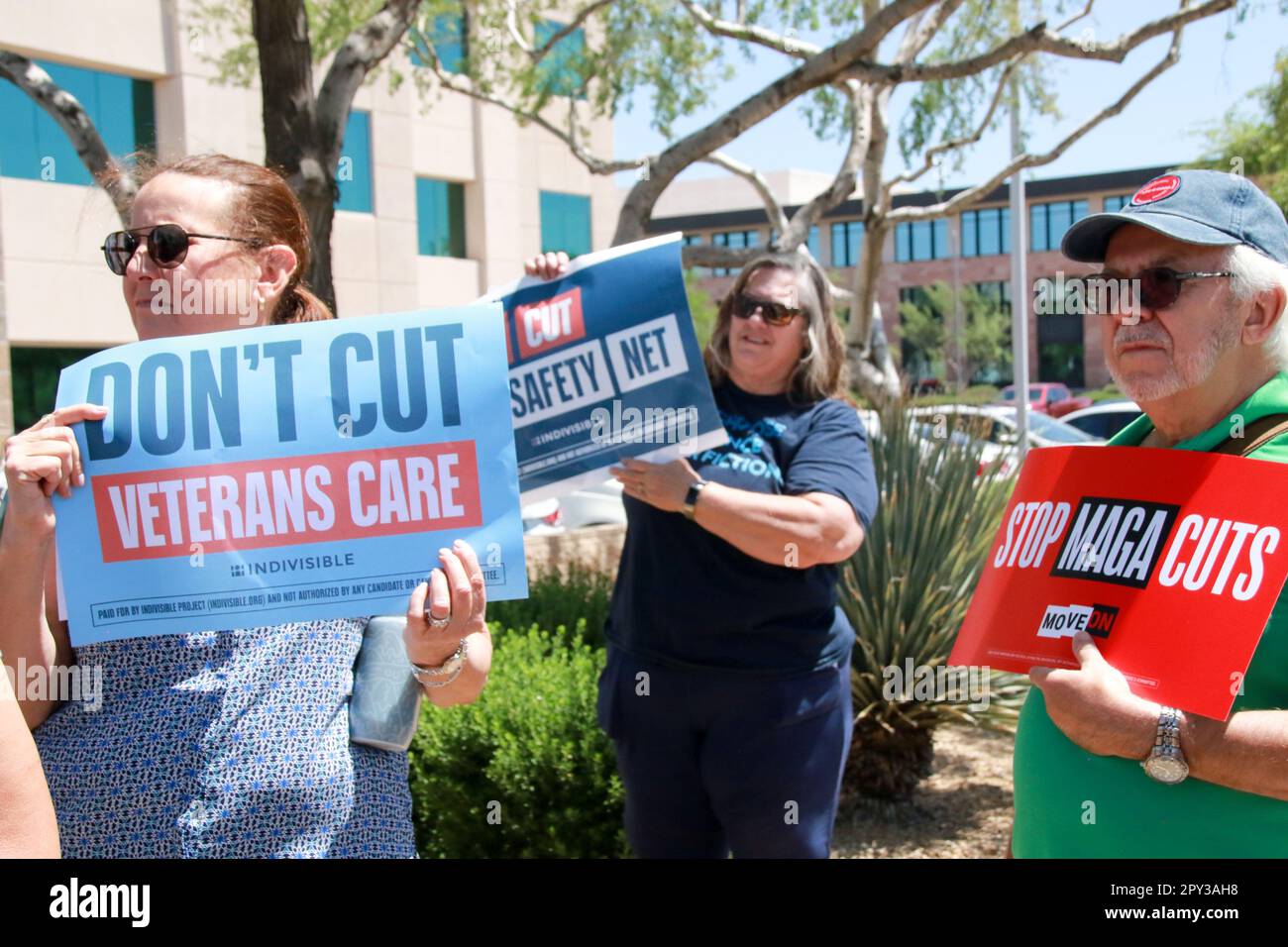 People rally outside the office of U.S. Representative David Schweikert ...