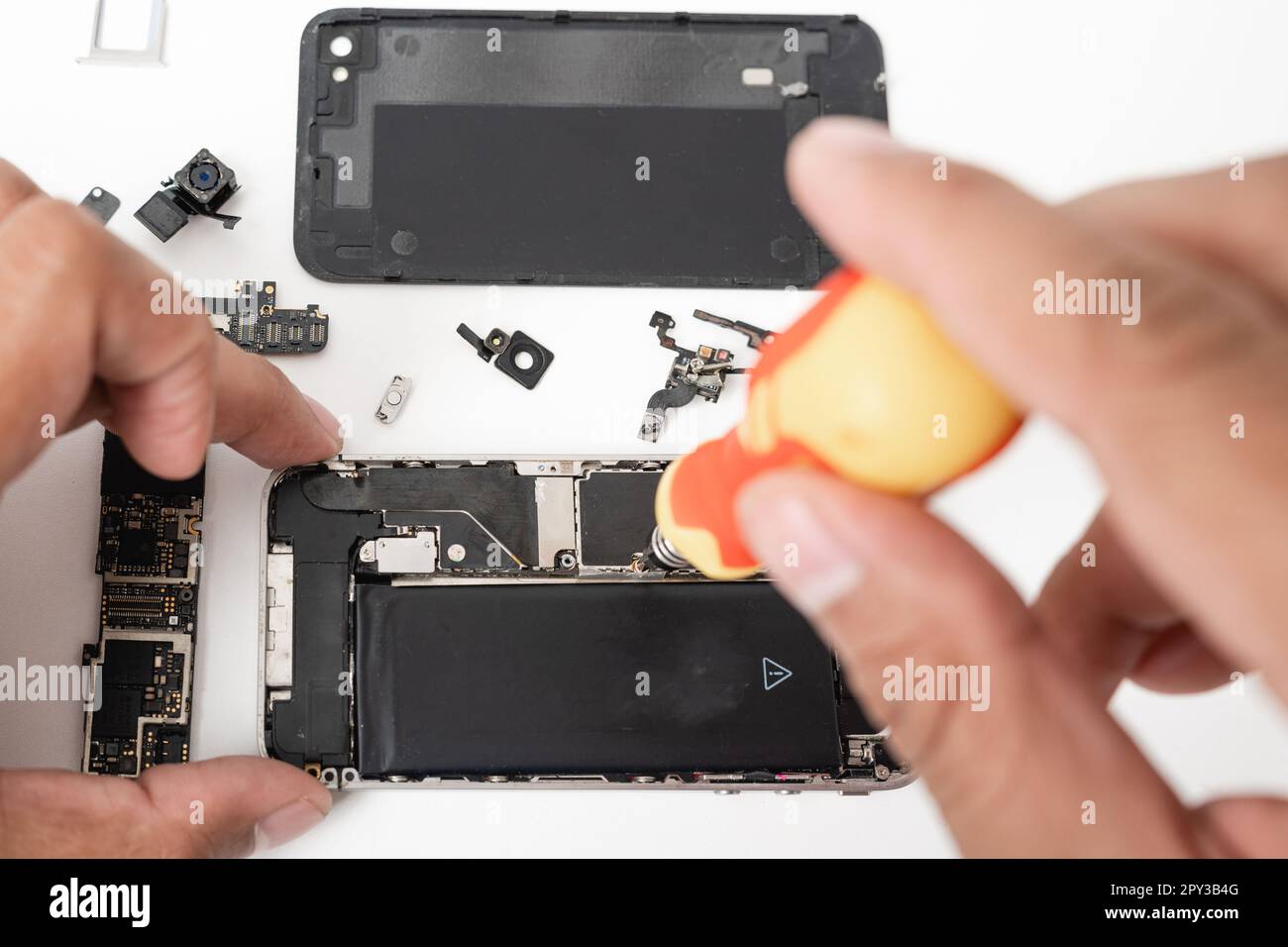 Technician repairing inside the smartphone motherboard with tools for ...