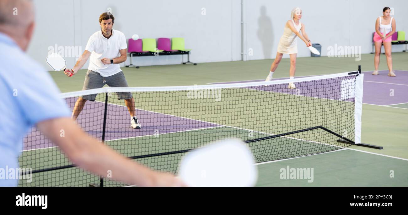 Pickleball game - people actively kicks the ball during pickleball game ...