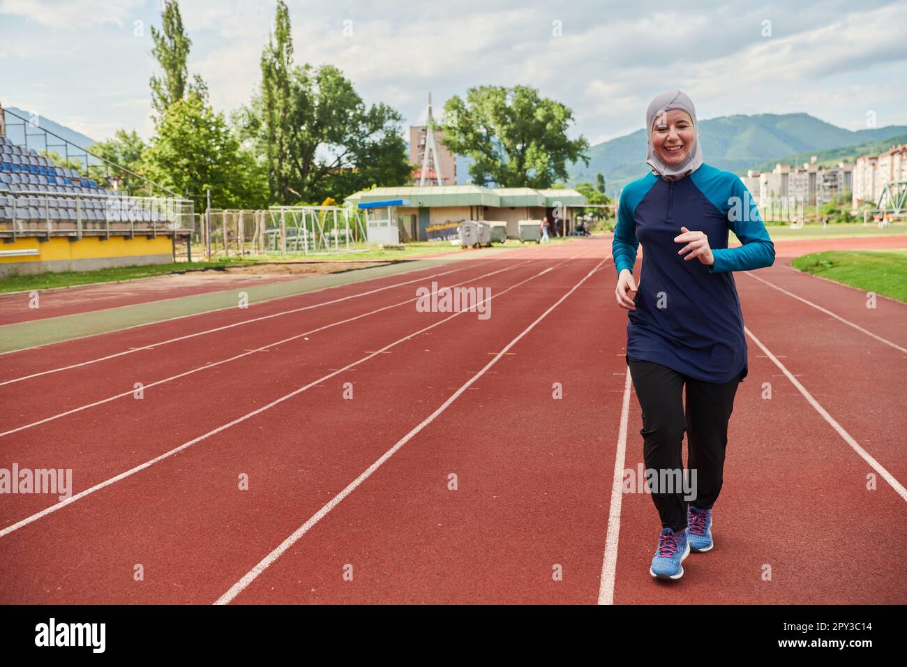 A muslim woman in a burqa sports muslim clothes running on a marathon ...