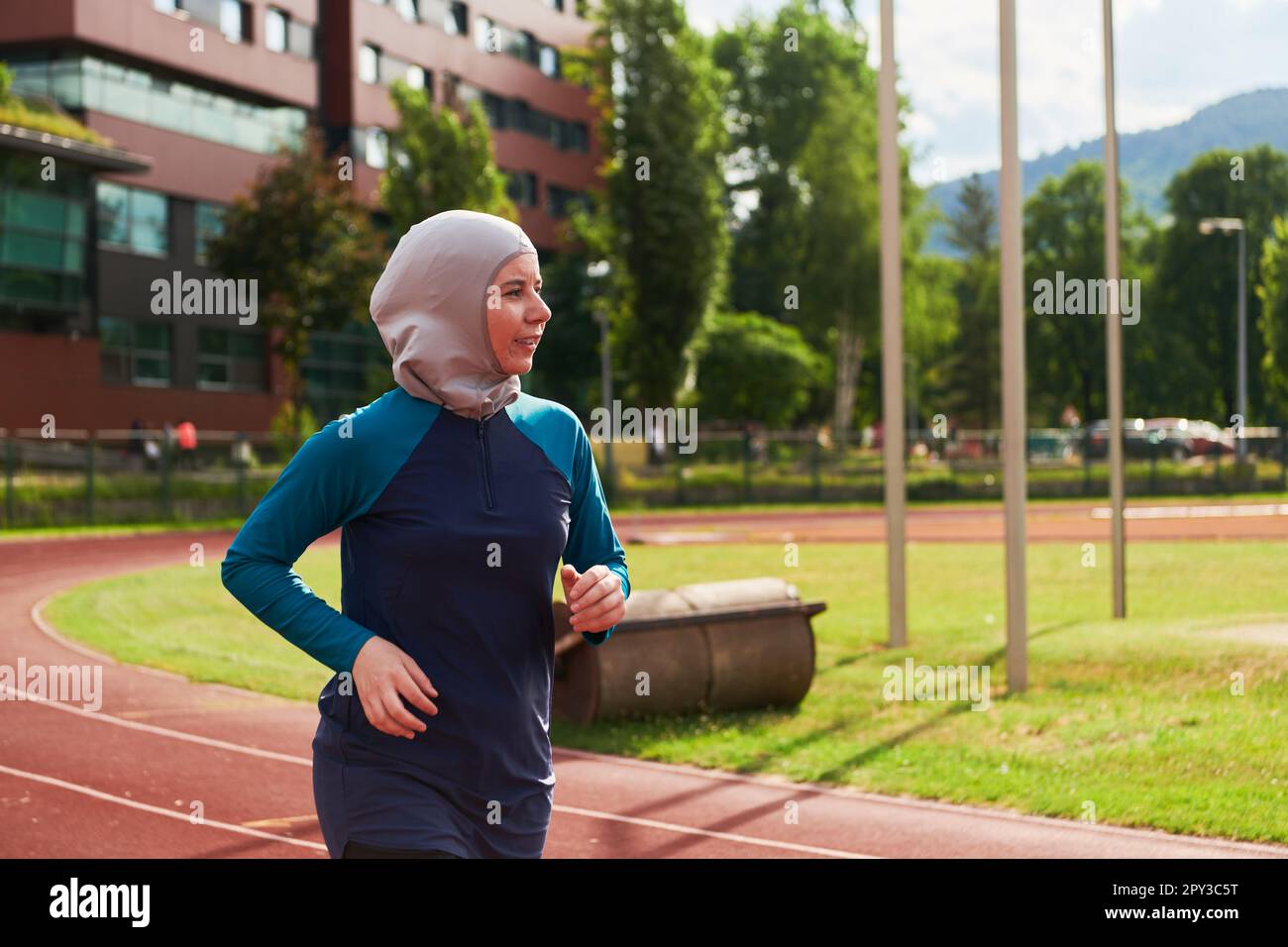 A muslim woman in a burqa sports muslim clothes running on a marathon ...