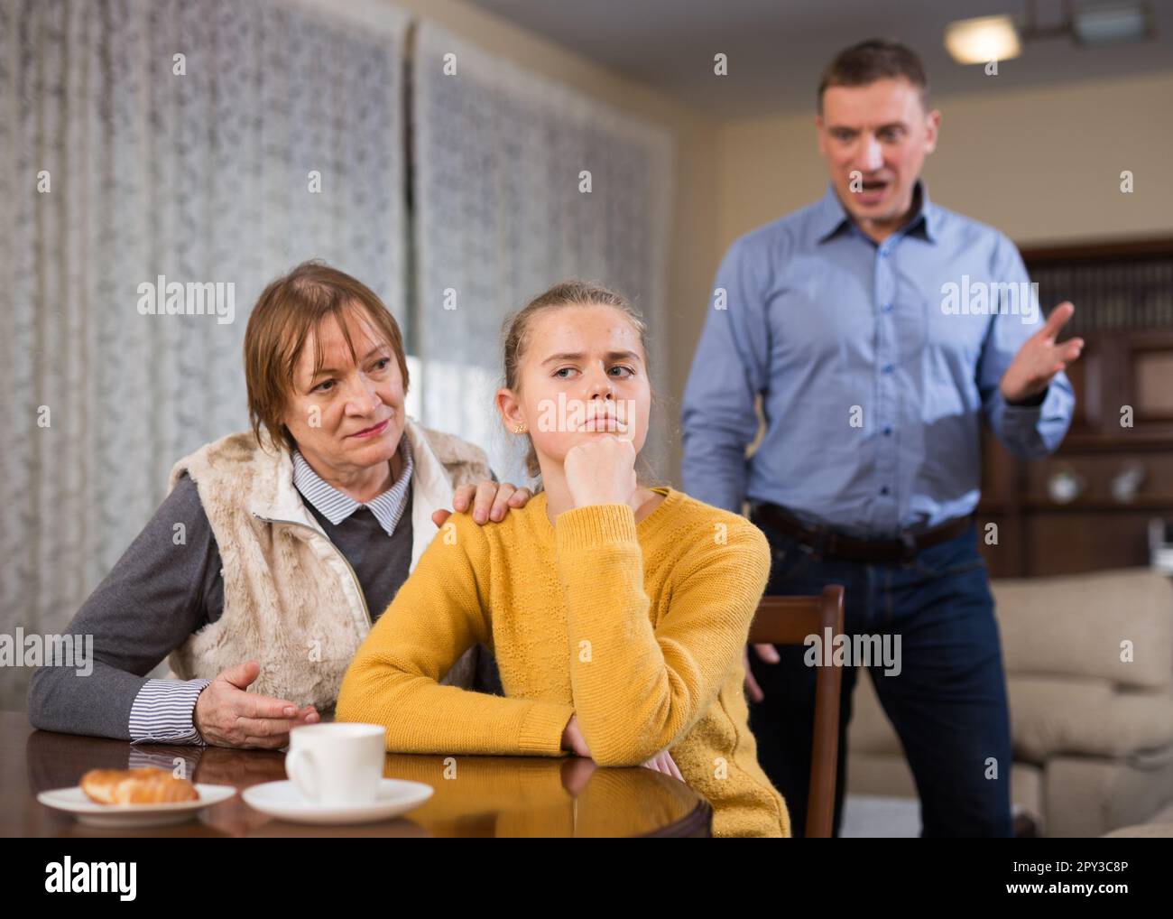 Woman and man lecturing teenage girl Stock Photo - Alamy