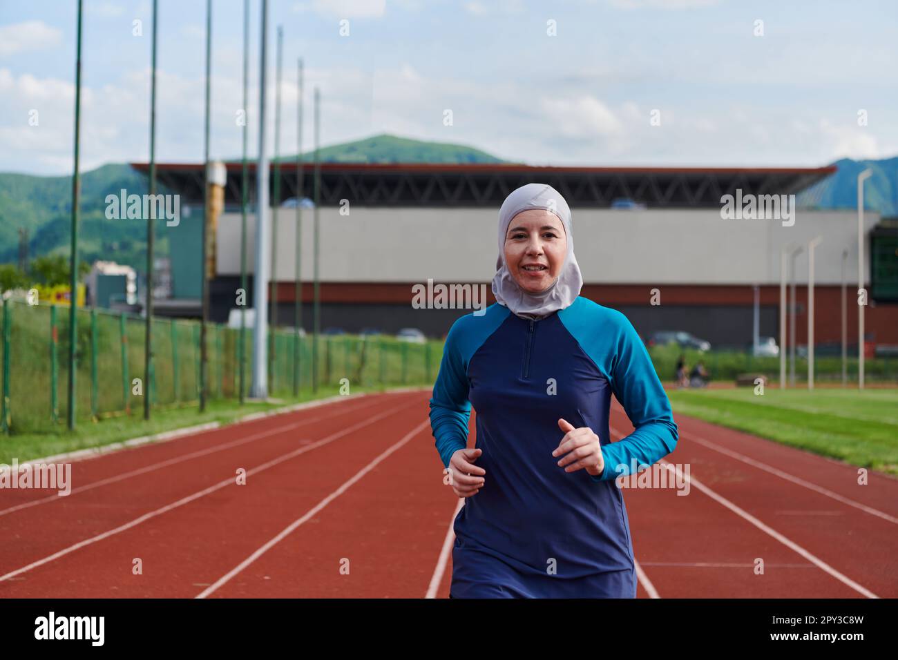 A muslim woman in a burqa sports muslim clothes running on a marathon ...
