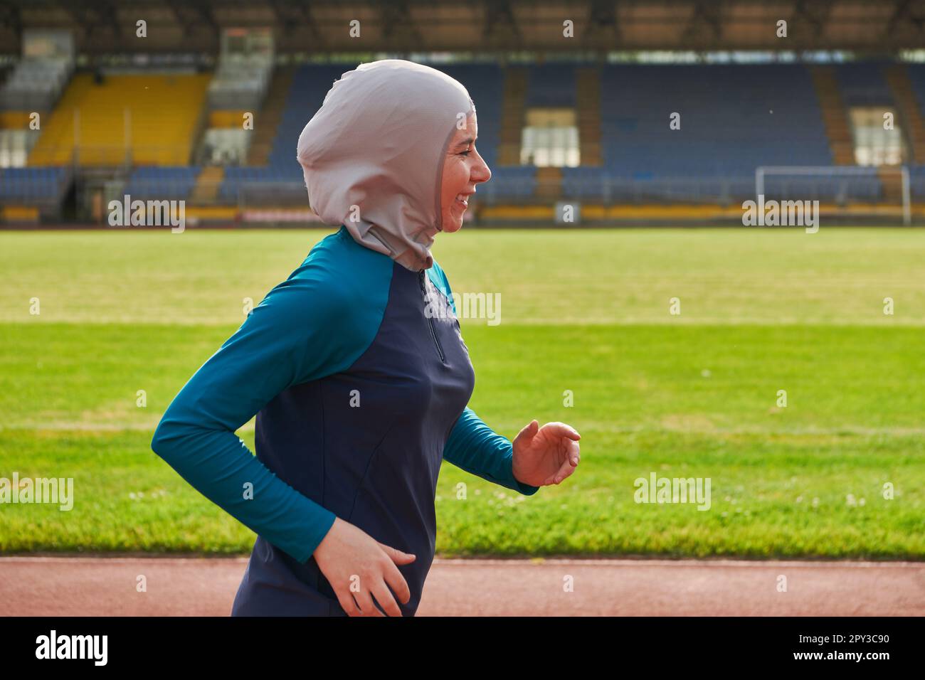 A muslim woman in a burqa sports muslim clothes running on a marathon ...