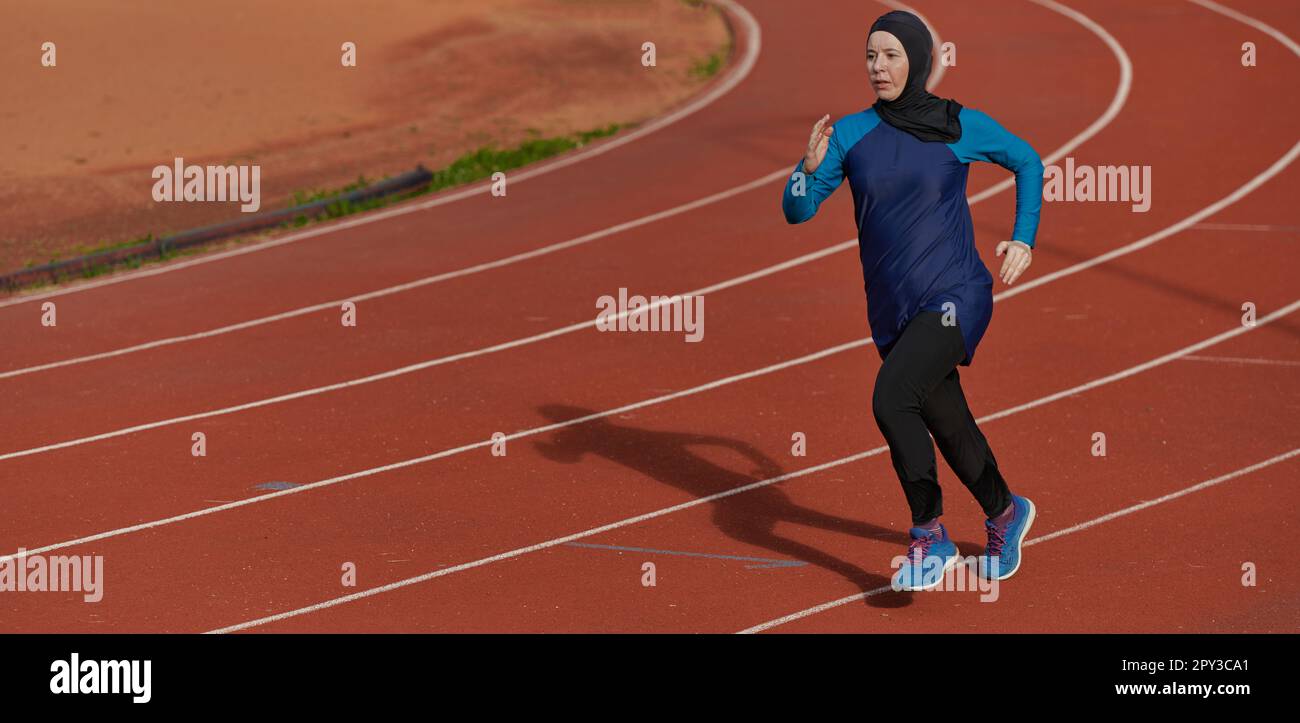 A muslim woman in a burqa sports muslim clothes running on a marathon ...