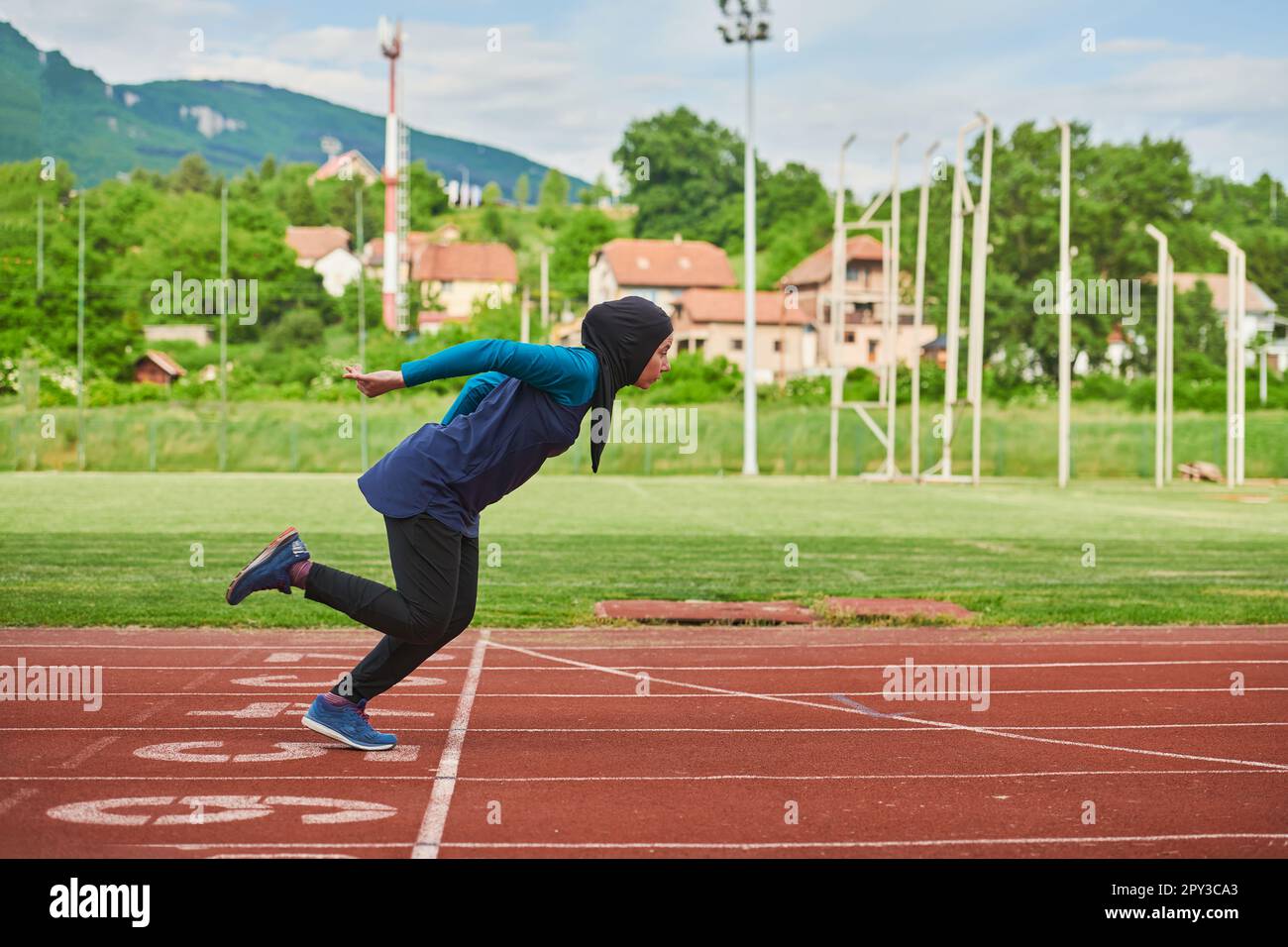 A muslim woman in a burqa sports muslim clothes running on a marathon ...
