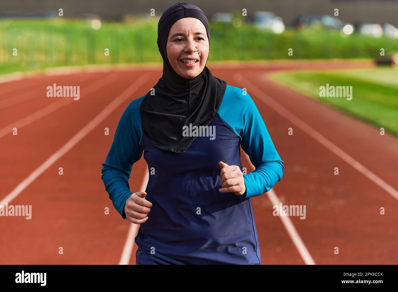A muslim woman in a burqa sports muslim clothes running on a marathon ...