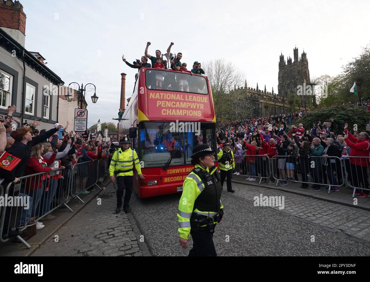 Wrexham players celebrate on an open-top bus during a victory parade in ...