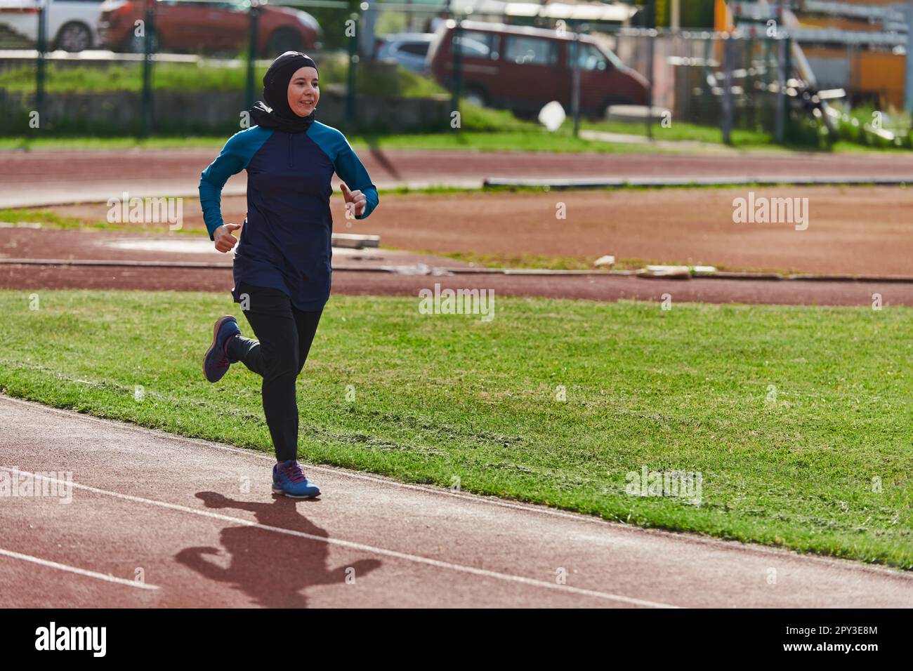 A muslim woman in a burqa sports muslim clothes running on a marathon ...
