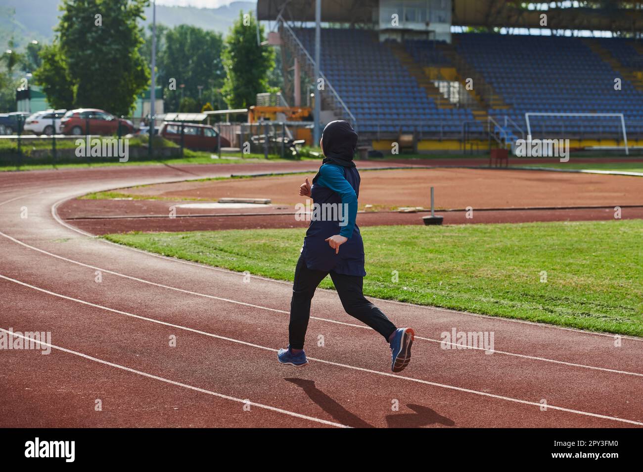 A muslim woman in a burqa sports muslim clothes running on a marathon ...