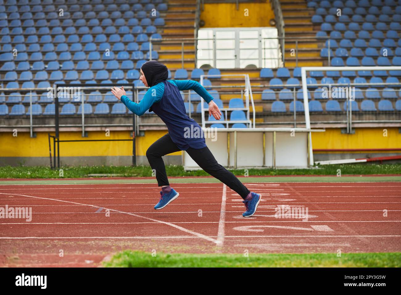 A muslim woman in a burqa sports muslim clothes running on a marathon ...