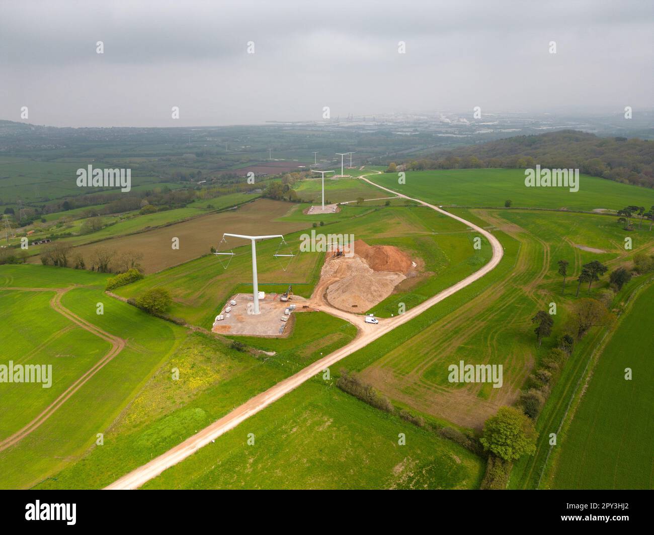 An aerial view of a vast expanse of land with T-pylons to connect a ...