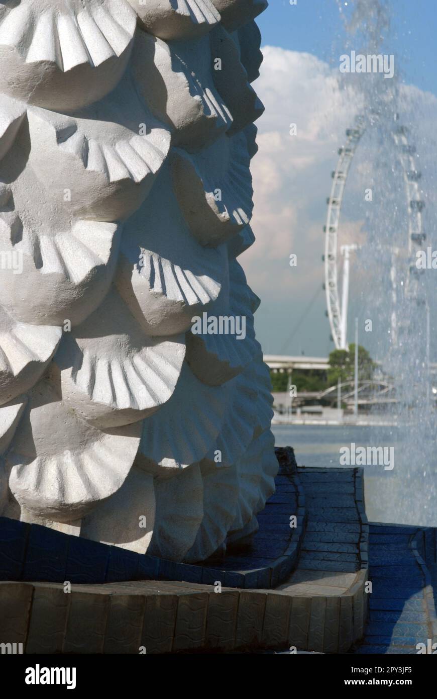 The Merlion Statue on the Esplanade with giant Singapore Ferris Wheel ...