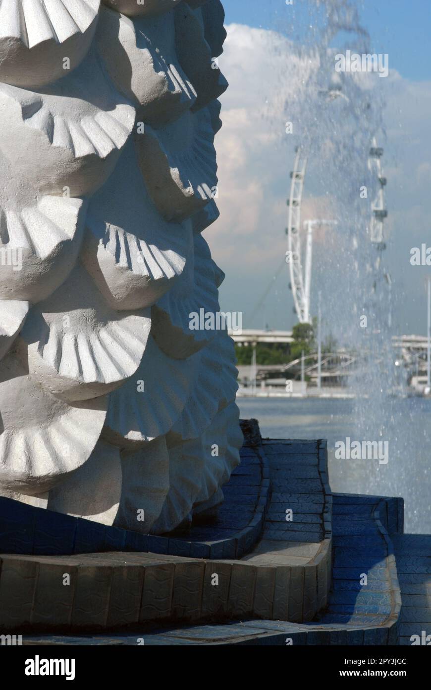 The Merlion Statue on the Esplanade with giant Singapore Ferris Wheel ...
