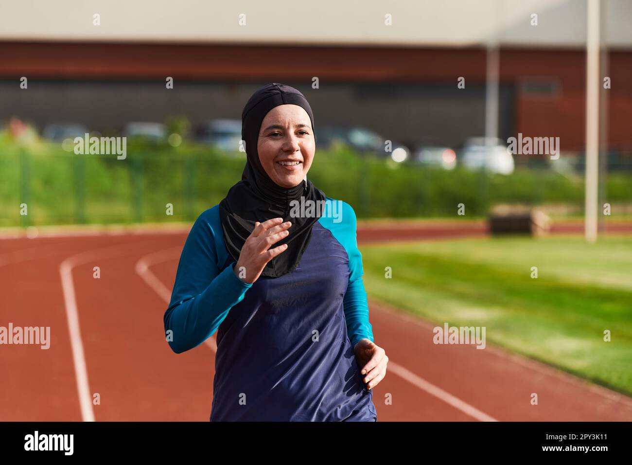 A muslim woman in a burqa sports muslim clothes running on a marathon ...