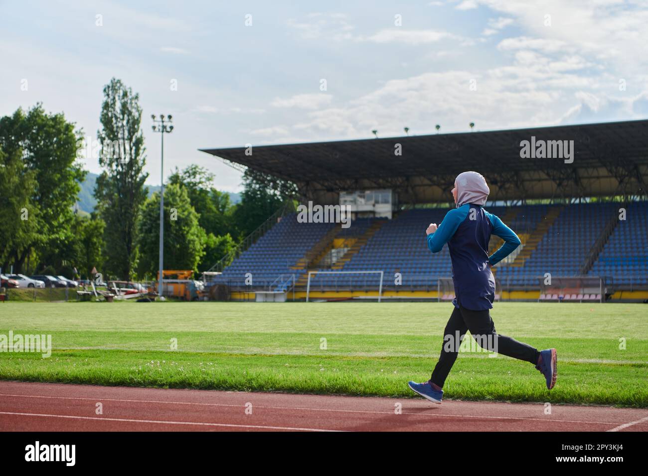 A muslim woman in a burqa sports muslim clothes running on a marathon ...