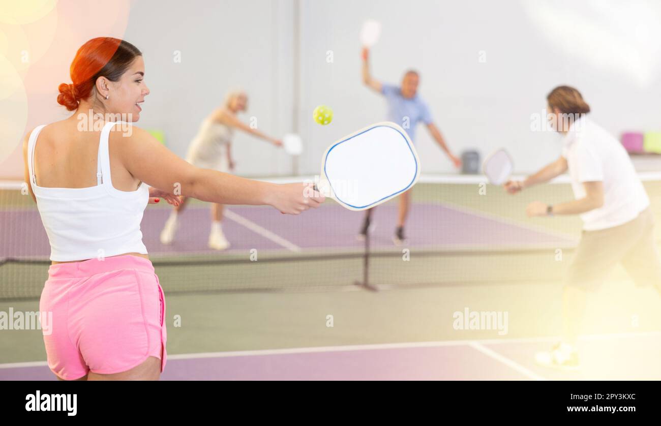 Rear view of girl with white racket playing pickleball tennis Stock ...
