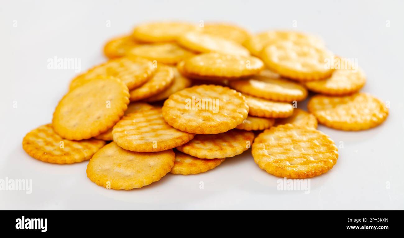 Crispy salted round crackers on white table Stock Photo - Alamy