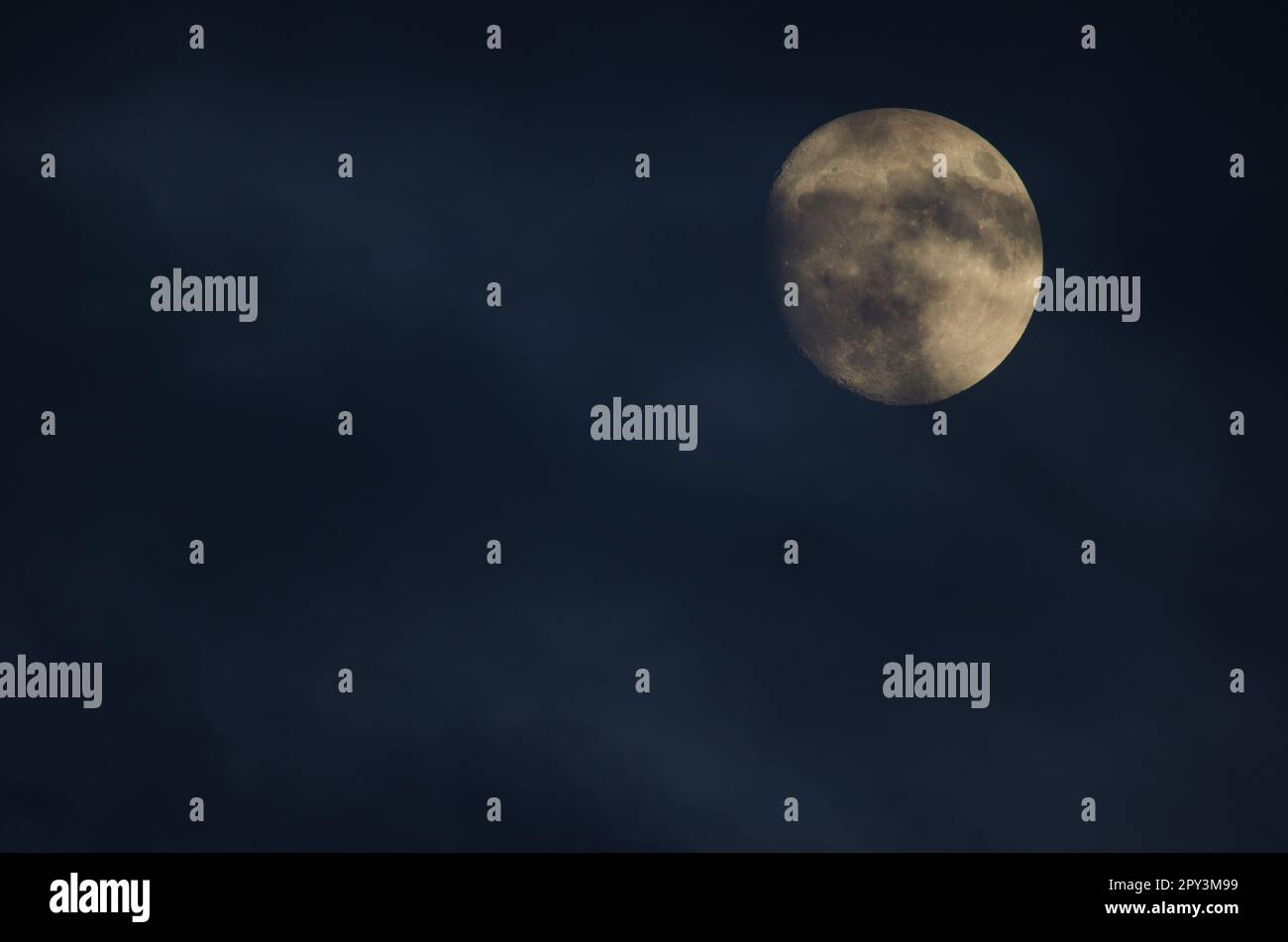 Waxing gibbous moon at sunset between clouds. Kiyosato. Hokkaido. Japan ...