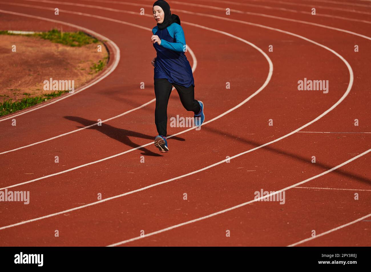 A muslim woman in a burqa sports muslim clothes running on a marathon ...