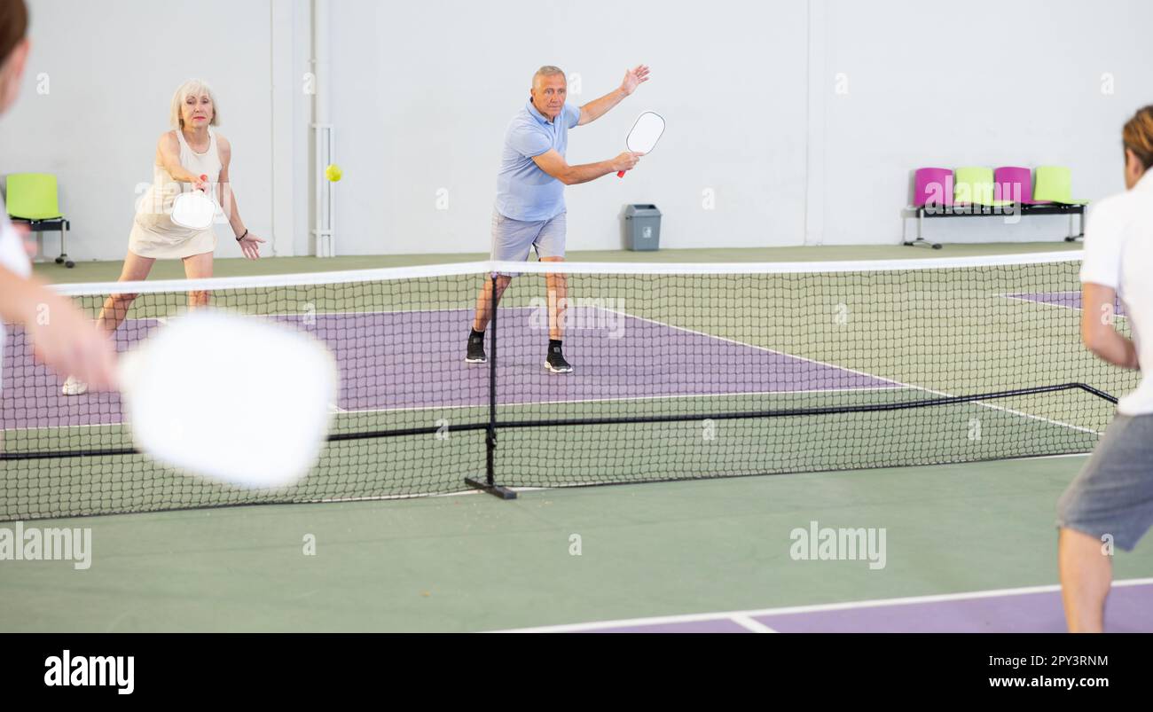 Pickleball game - people actively kicks the ball during pickleball game ...