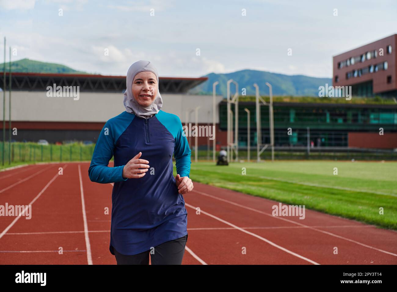 A muslim woman in a burqa sports muslim clothes running on a marathon ...