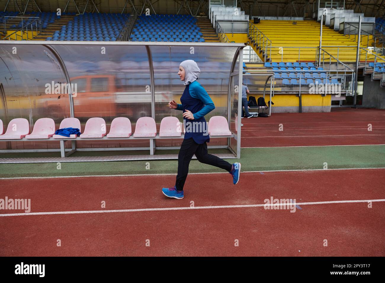 A muslim woman in a burqa sports muslim clothes running on a marathon ...