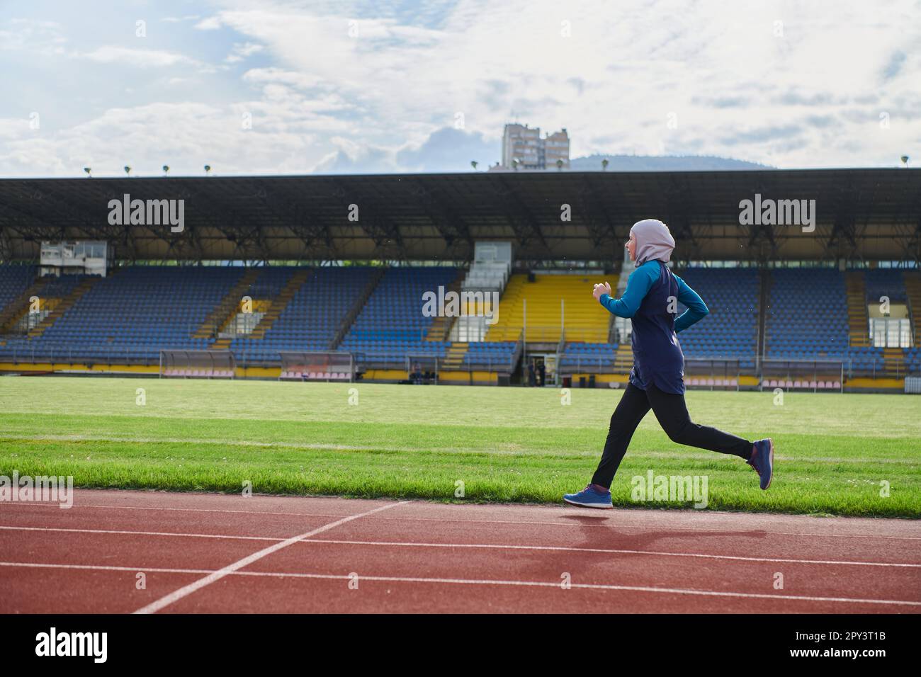 A muslim woman in a burqa sports muslim clothes running on a marathon ...