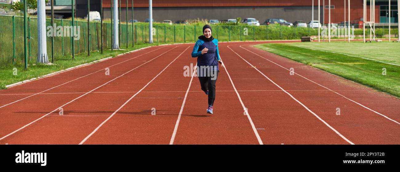 A muslim woman in a burqa sports muslim clothes running on a marathon ...