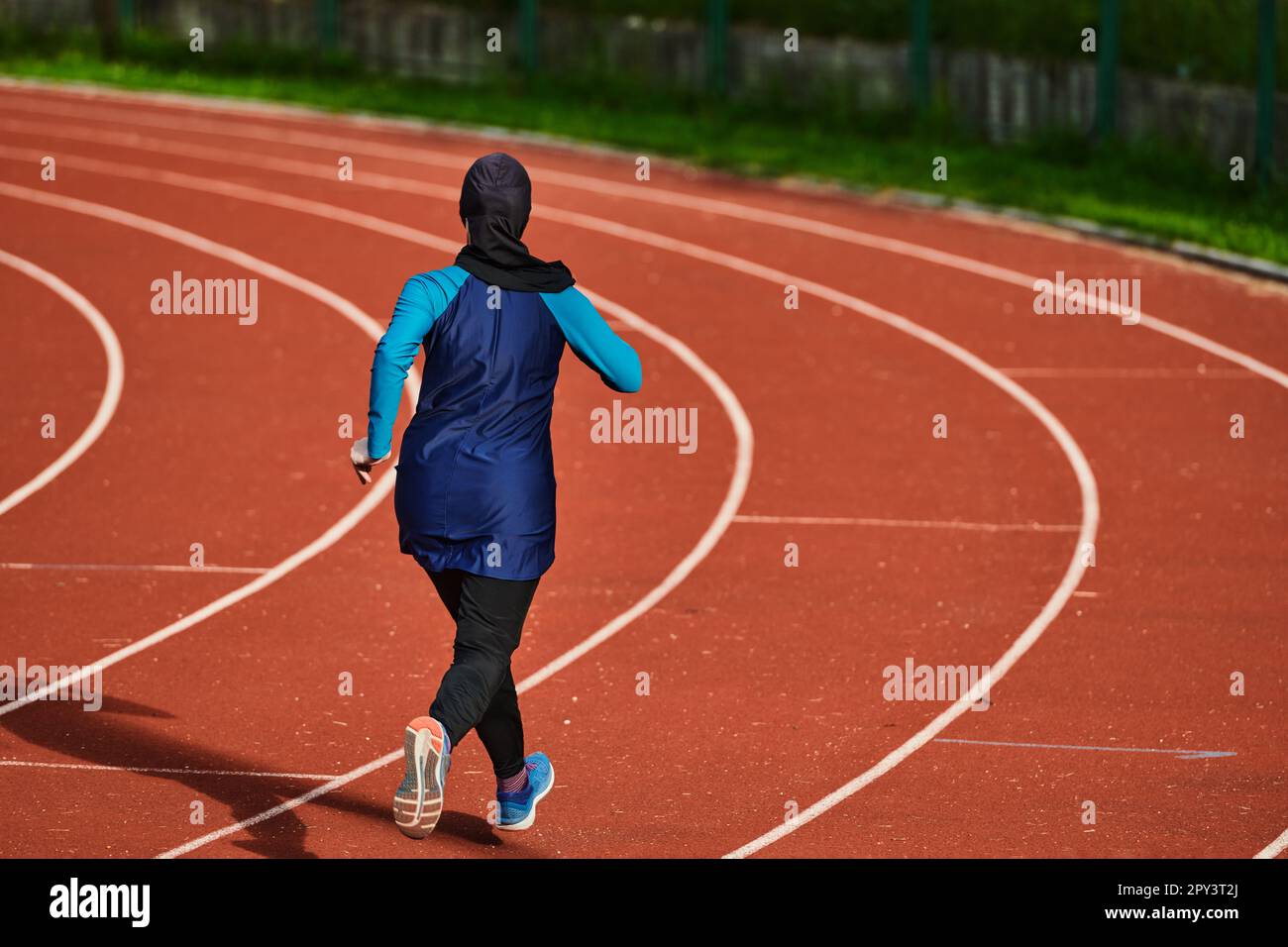 A muslim woman in a burqa sports muslim clothes running on a marathon ...