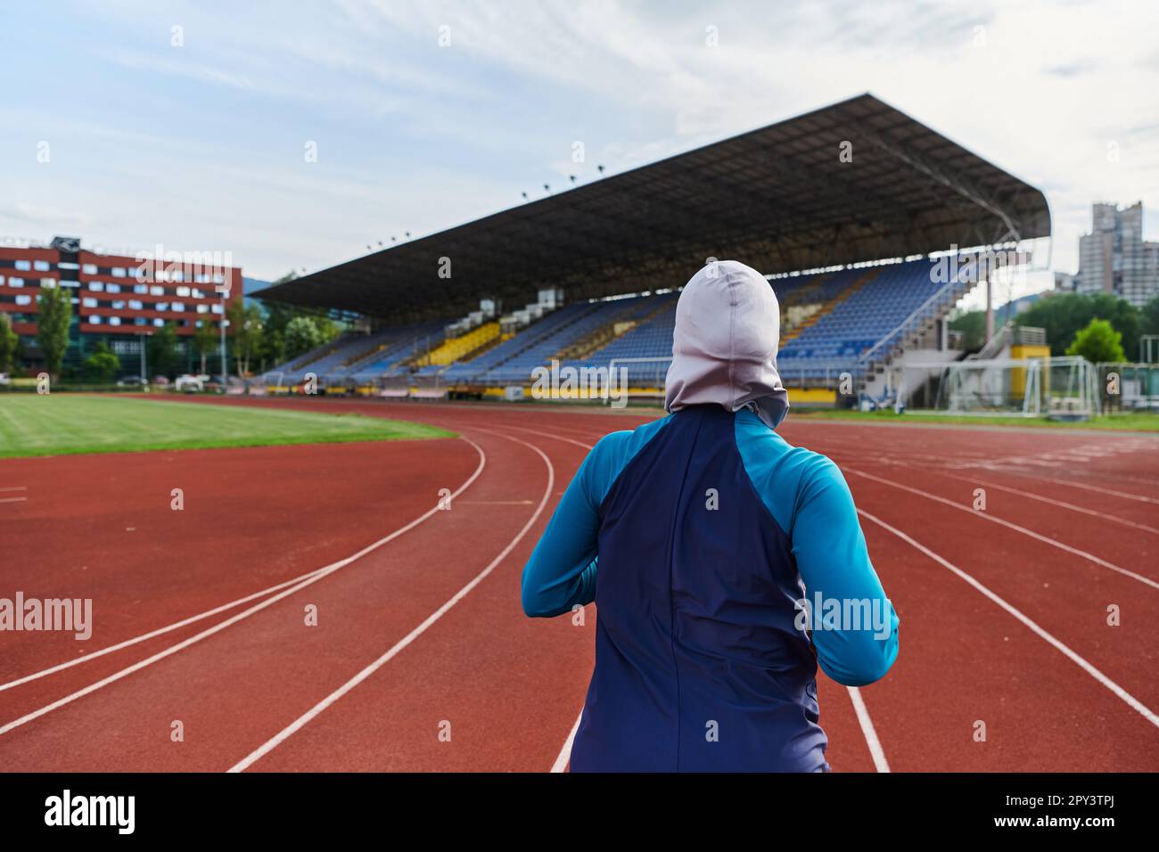 A muslim woman in a burqa sports muslim clothes running on a marathon ...