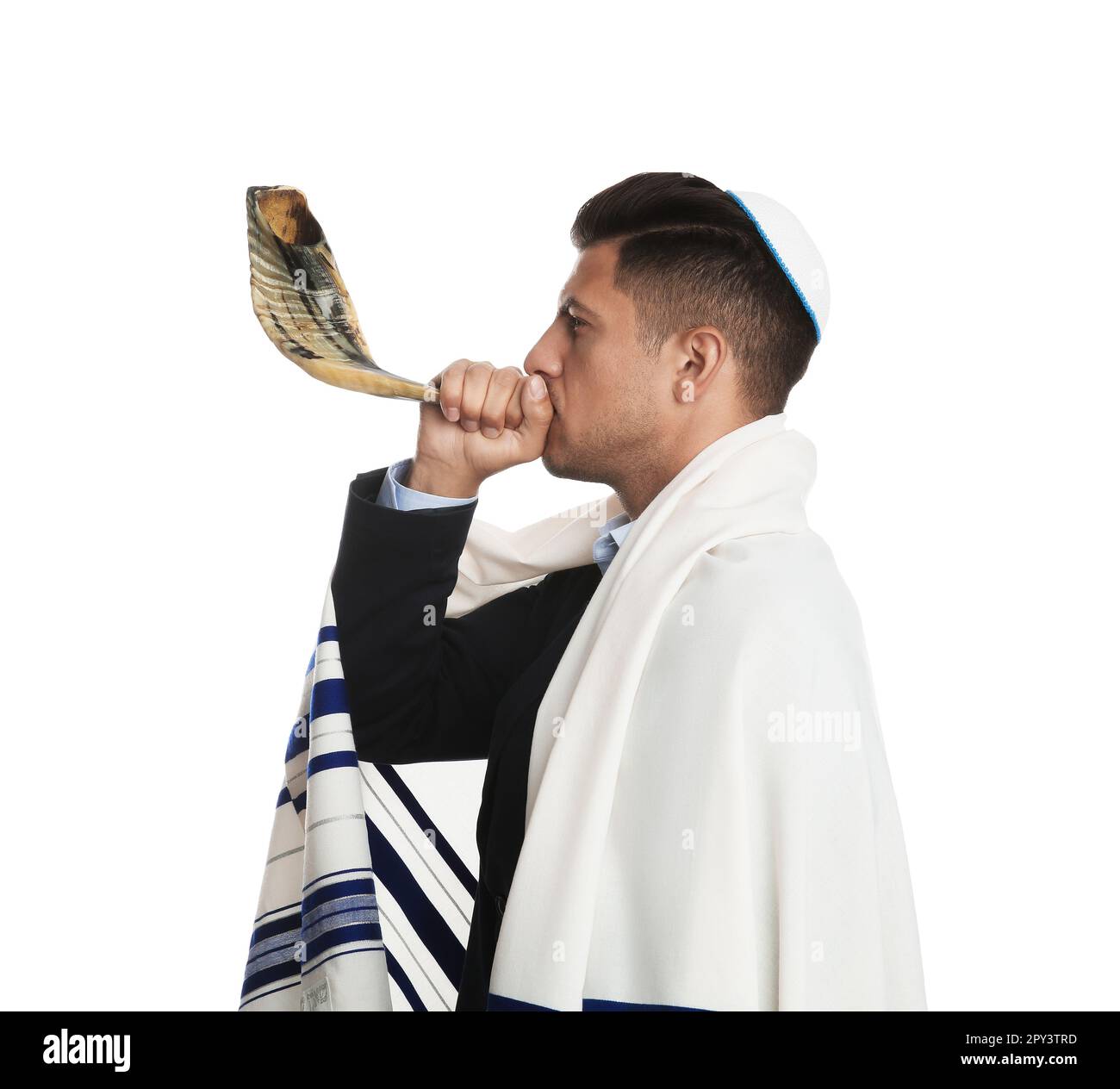 Jewish man with kippah and tallit blowing shofar on white background ...