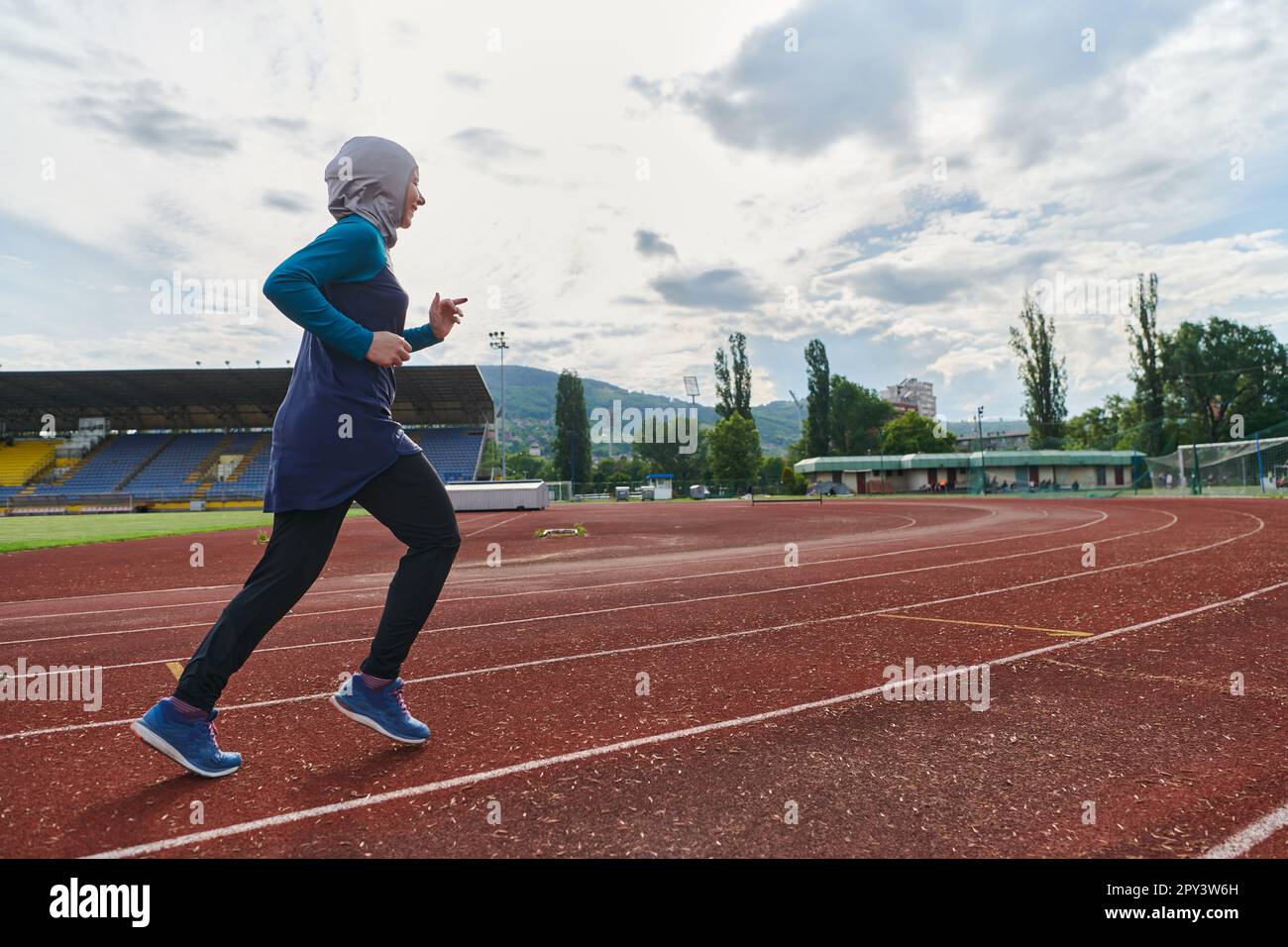 A muslim woman in a burqa sports muslim clothes running on a marathon ...
