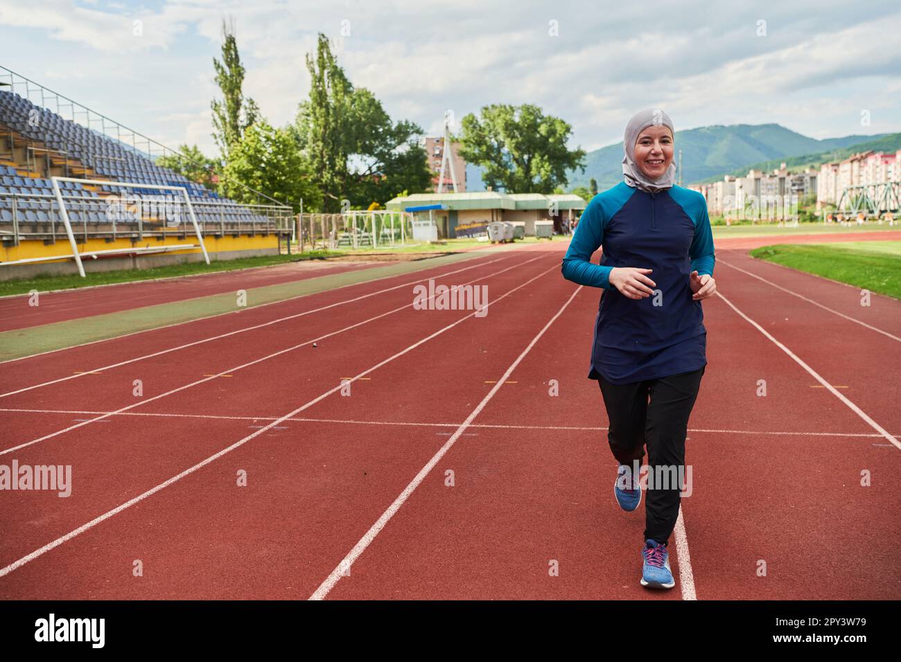 A muslim woman in a burqa sports muslim clothes running on a marathon ...