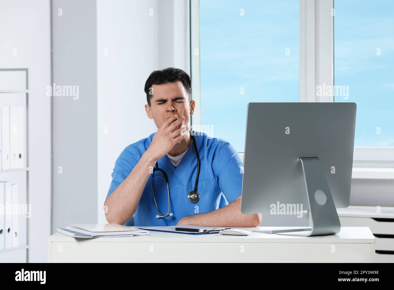 Doctor yawning hi-res stock photography and images - Alamy