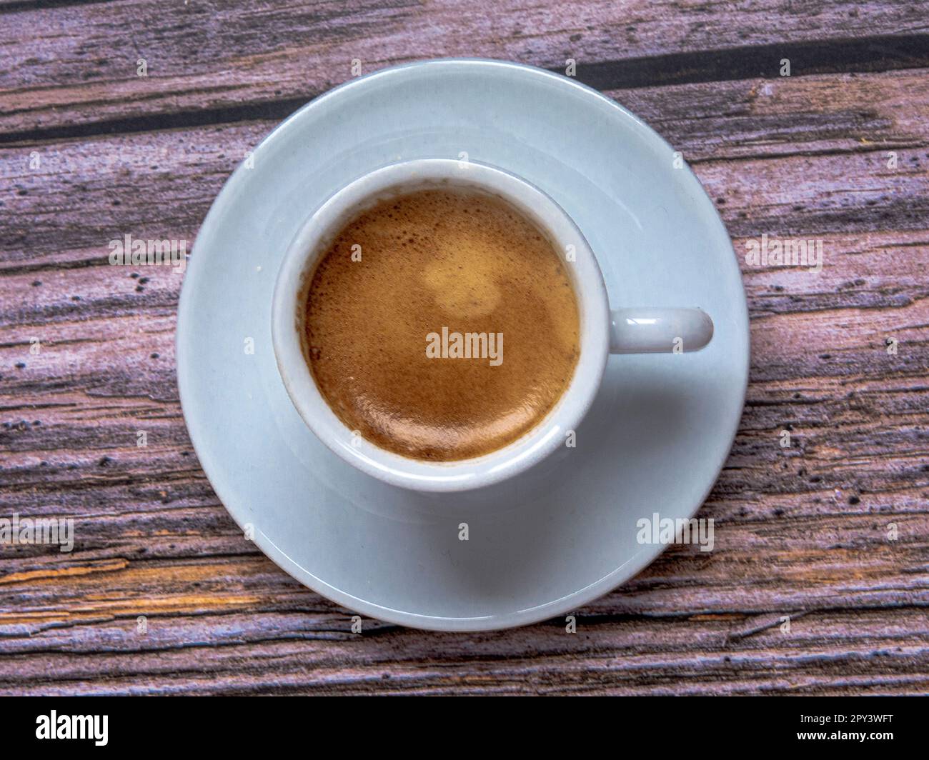 Cup of coffee with spoon on a rustic background. It has negative space ...