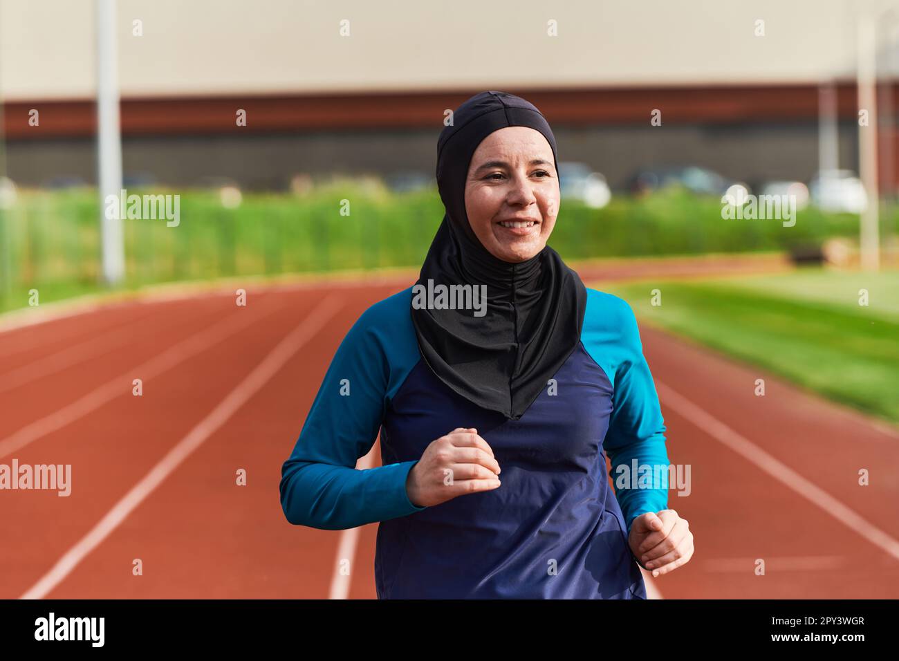 A muslim woman in a burqa sports muslim clothes running on a marathon ...